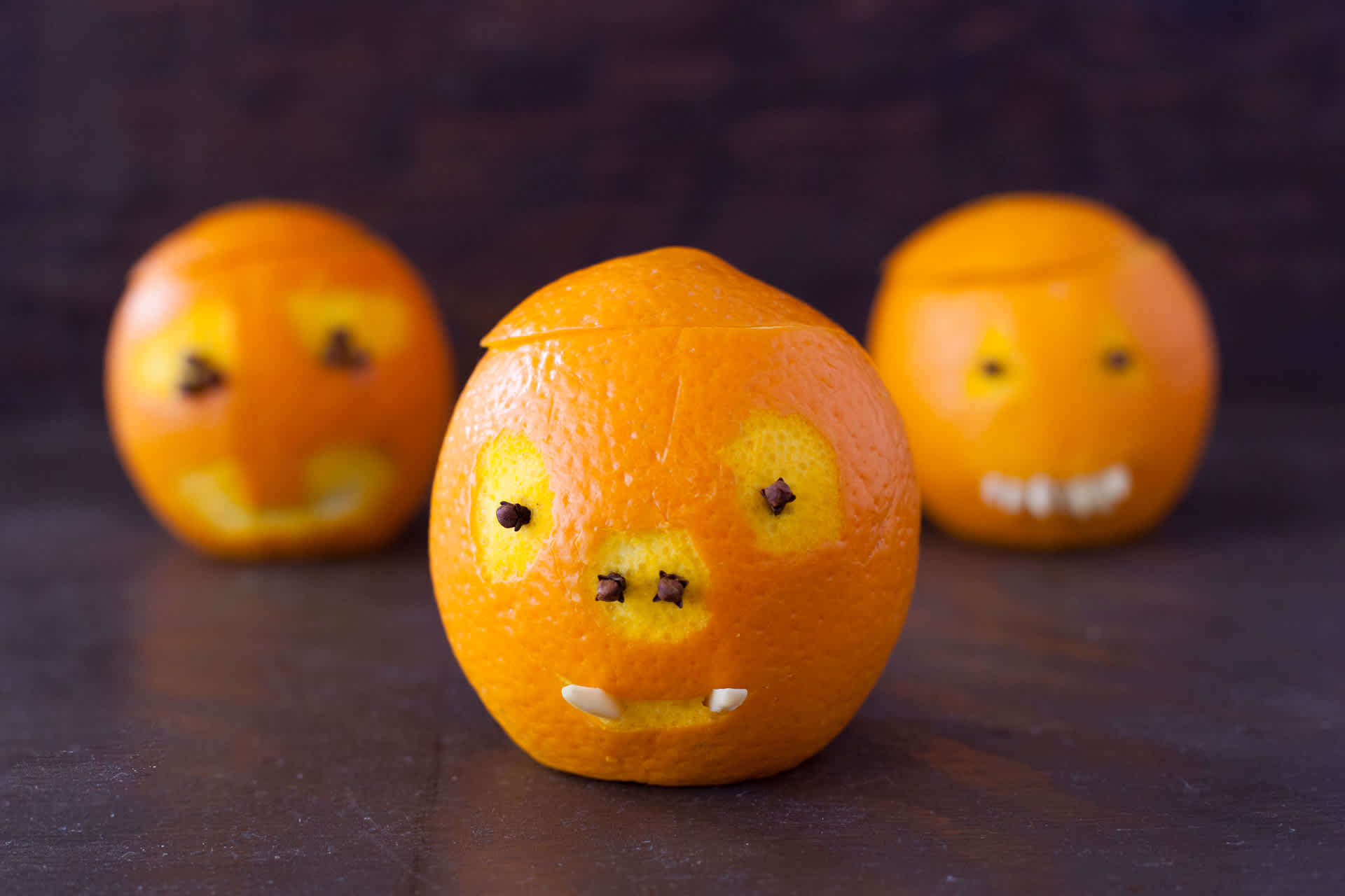 oranges with pumpkin faces